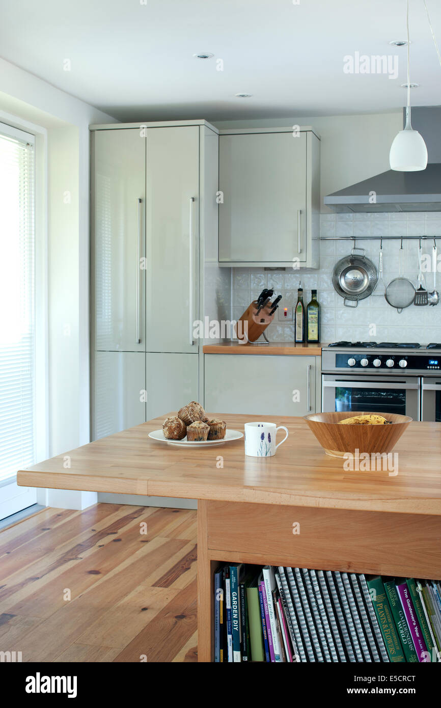 Looking across the end of the dining room table to the kitchen, UK ...