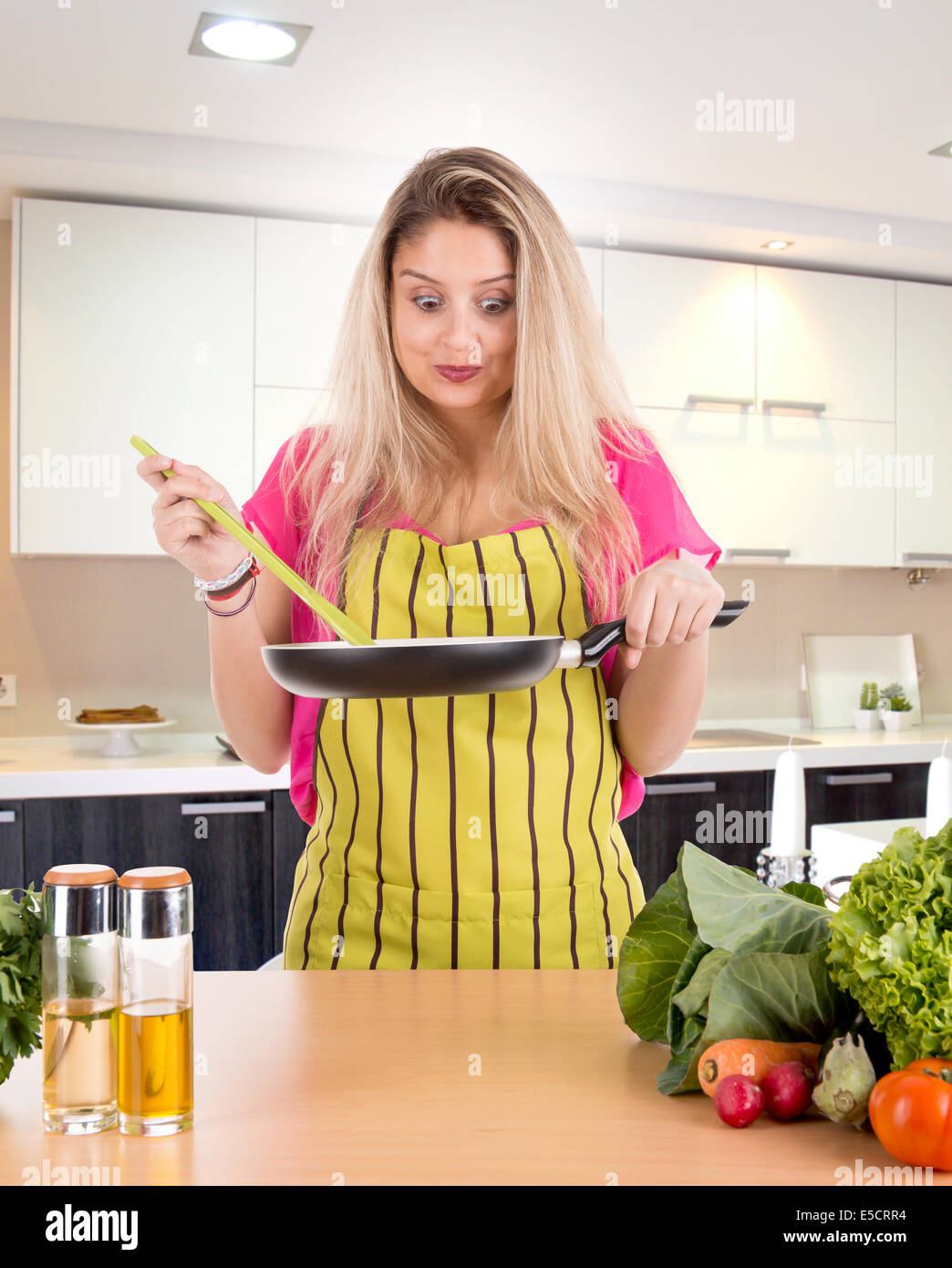 Beautiful woman cooking in the kitchen Stock Photo - Alamy