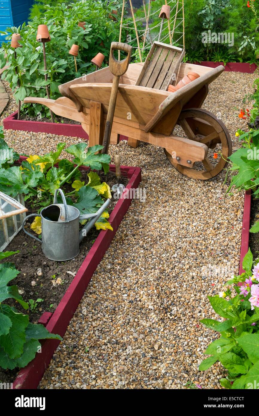 View of small raised bed crops with summer crops and traditional wooden ...