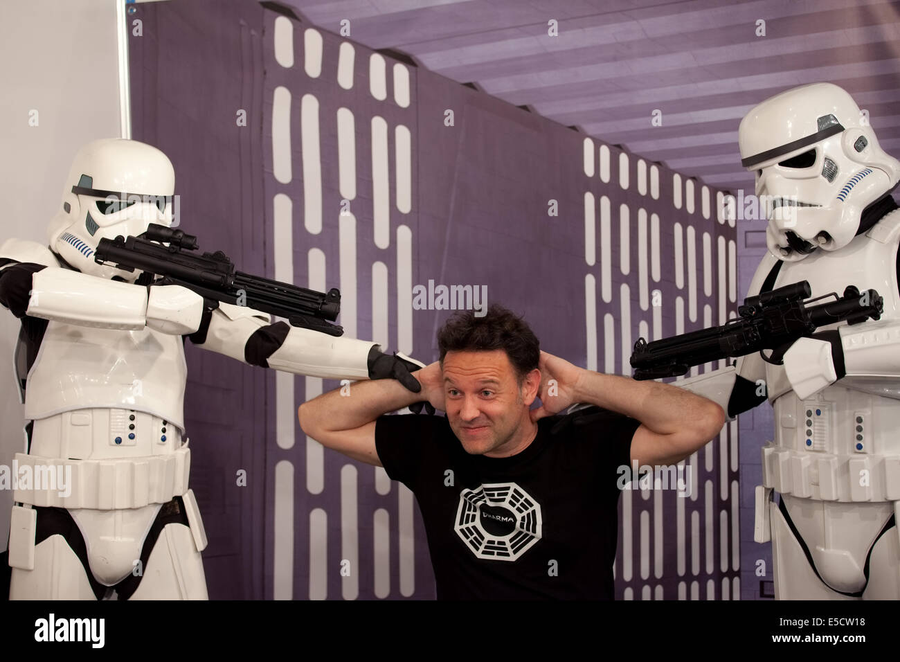 Stormtroopers from Star Wars pointing guns at a fan, Barcelona ...