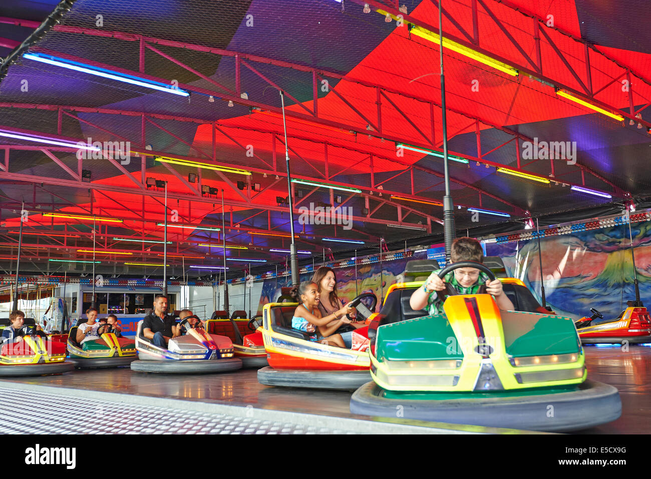 Some people having fun to drive a bumper car in the amusement park ...