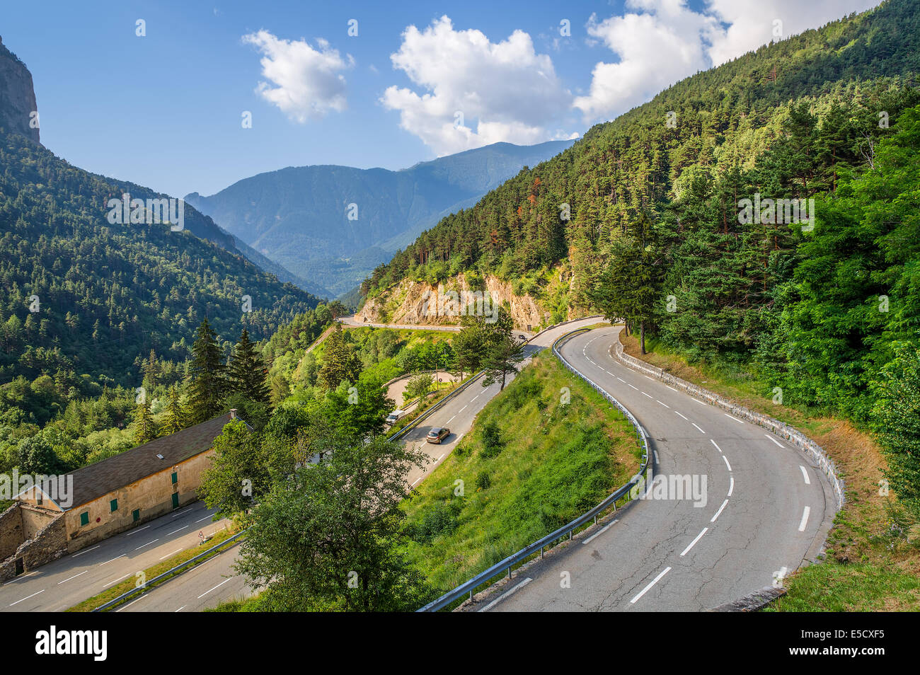 Narrow alpine highway on French-Italian border in Alps, France (view ...