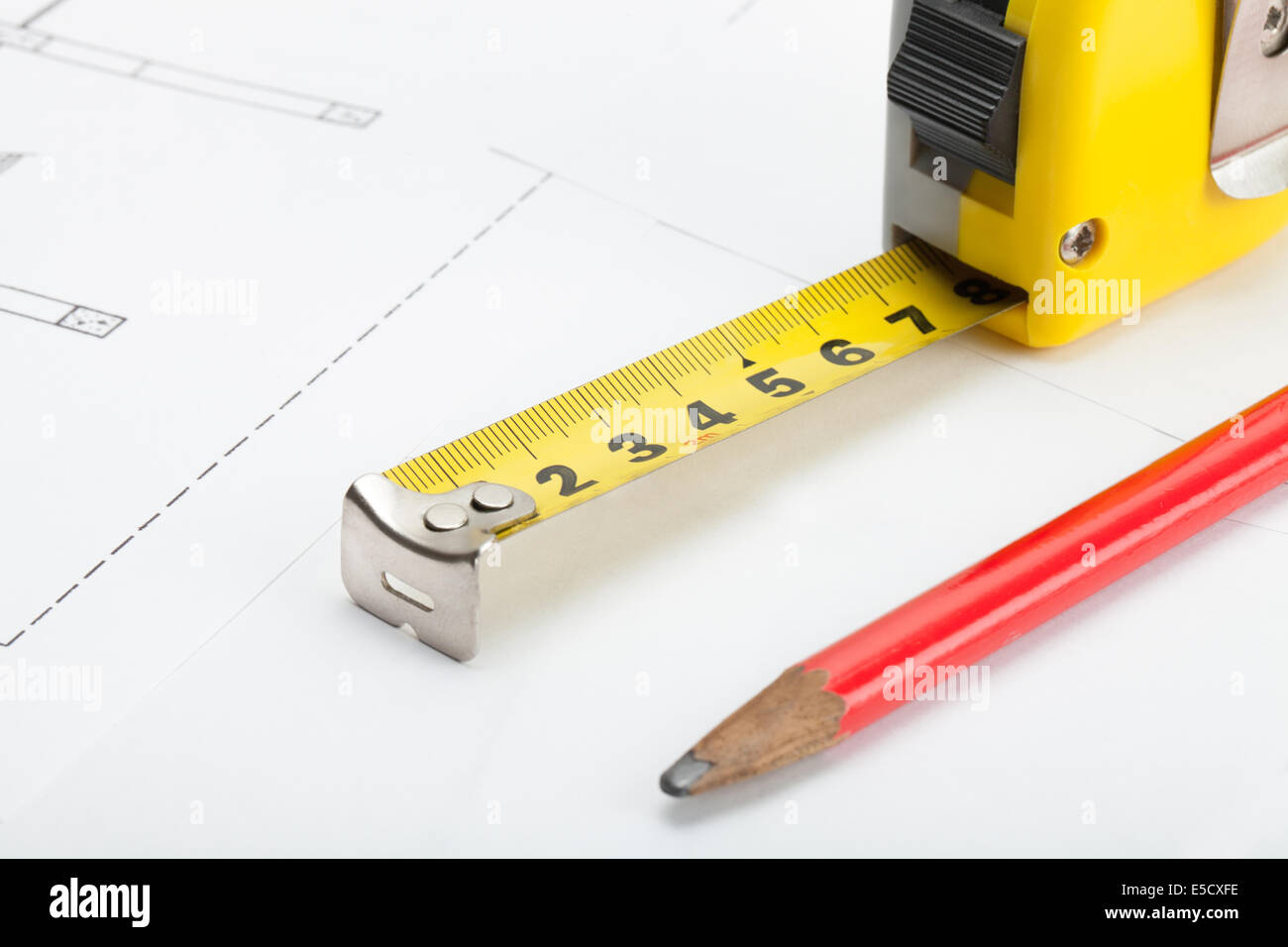 Tape measure with pencil above blueprint Stock Photo - Alamy