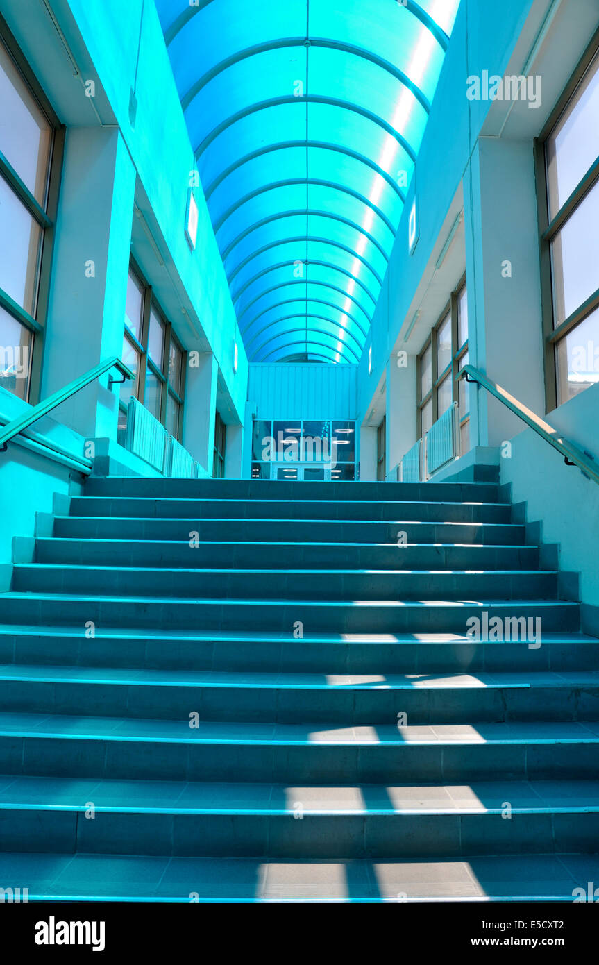 Interior of a modern building with ascending staircase and a ...