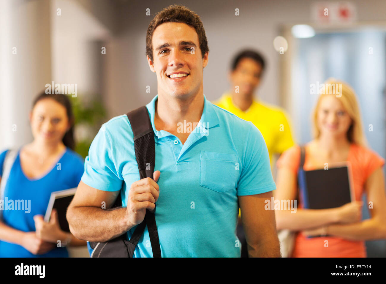 handsome male college student standing in front of friends Stock Photo ...