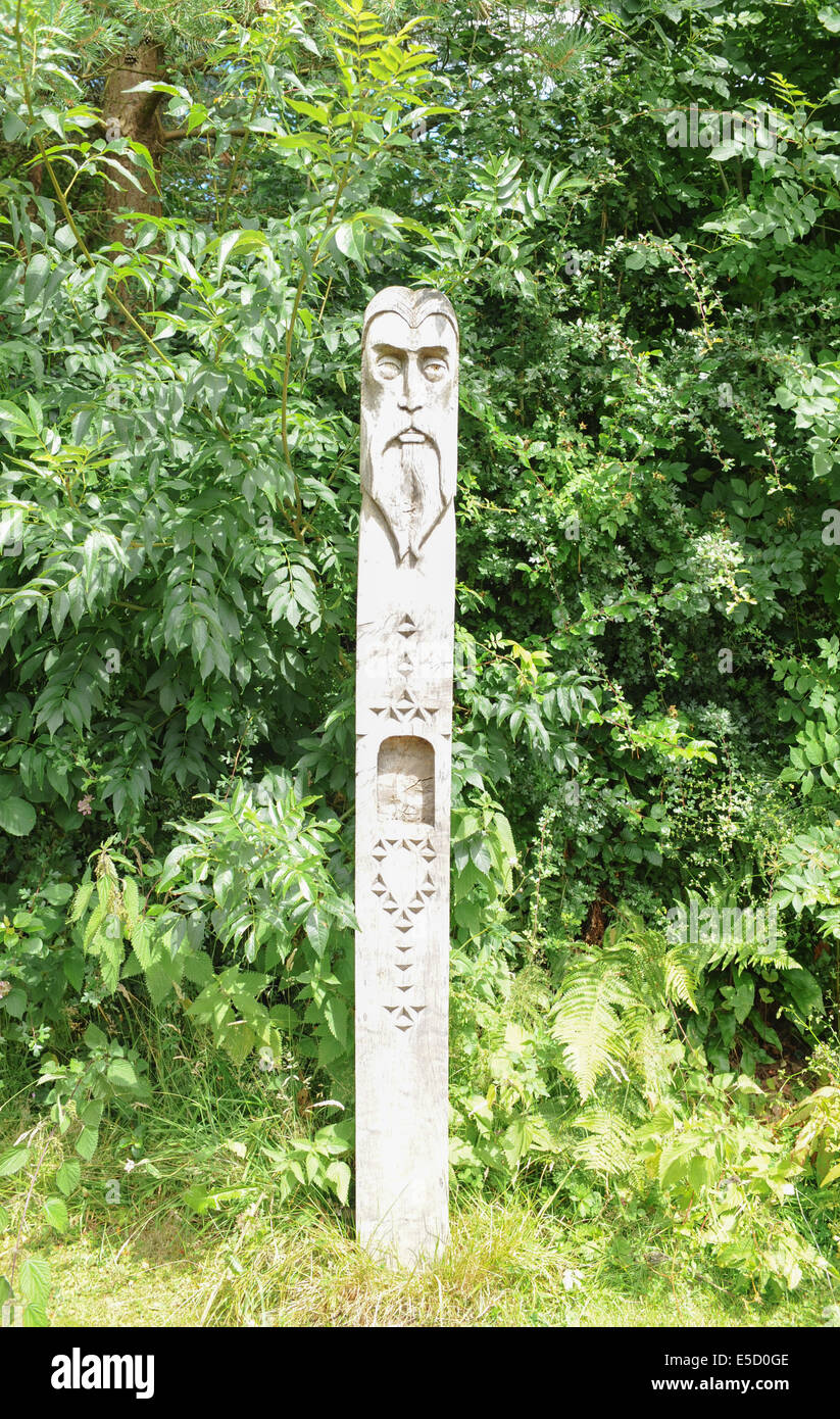 Carved wooden post of mythological figure in the gardens at Rosemoor ...