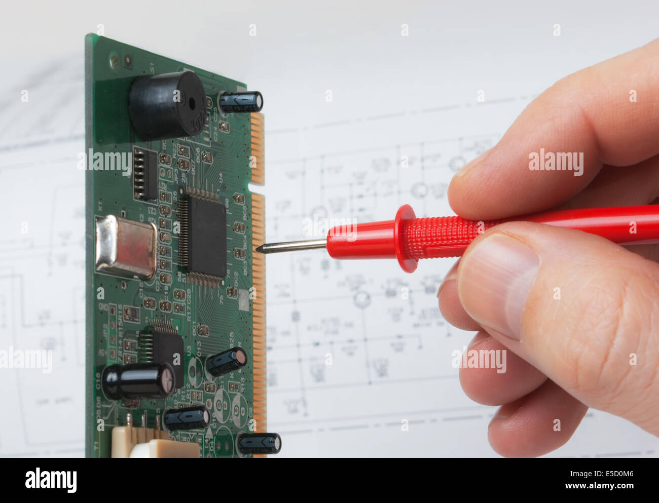 hand holds the instrument and tests electronic circuit boards Stock ...