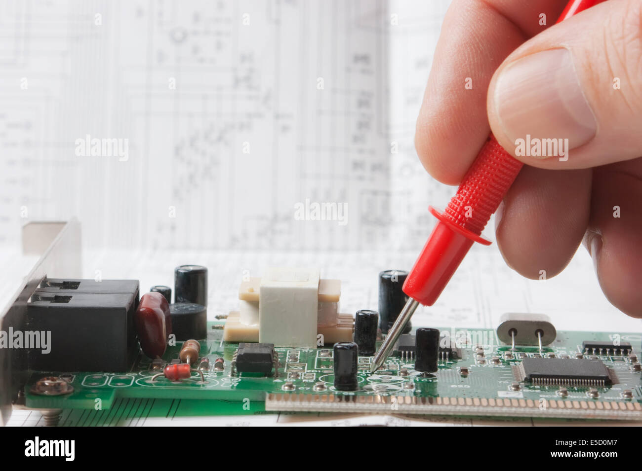 hand holds the instrument and tests electronic circuit boards Stock ...