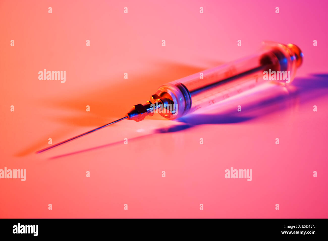 old glass syringe multicolored lights Stock Photo - Alamy