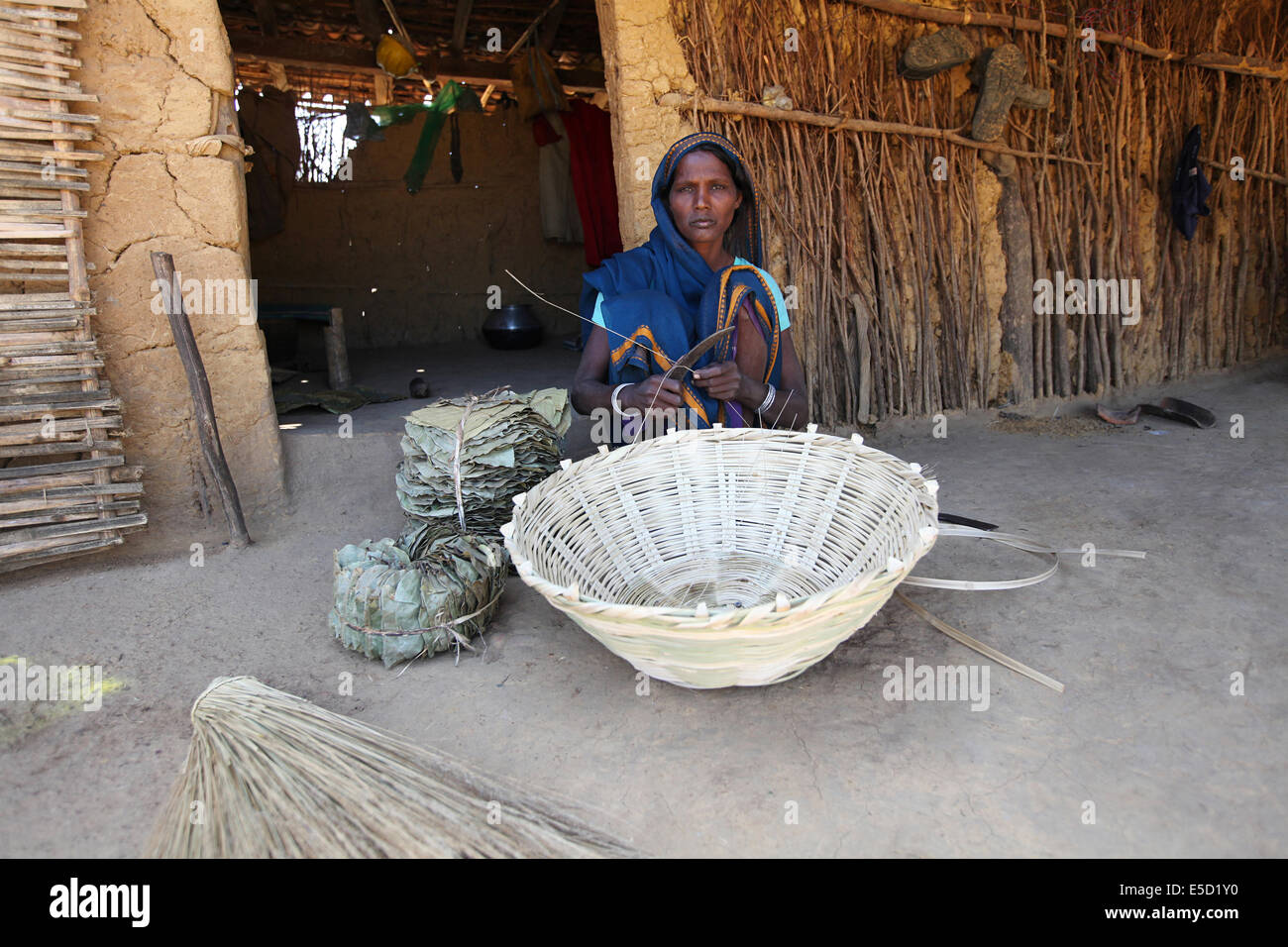 Tribal woman making baskets with dry bamboo strips. Birhor tribe ...