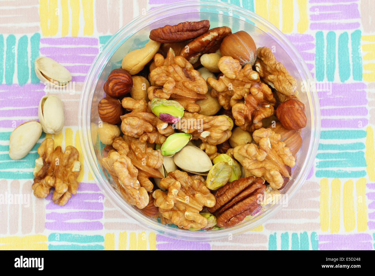 Mixed nuts in plastic box, close up Stock Photo - Alamy