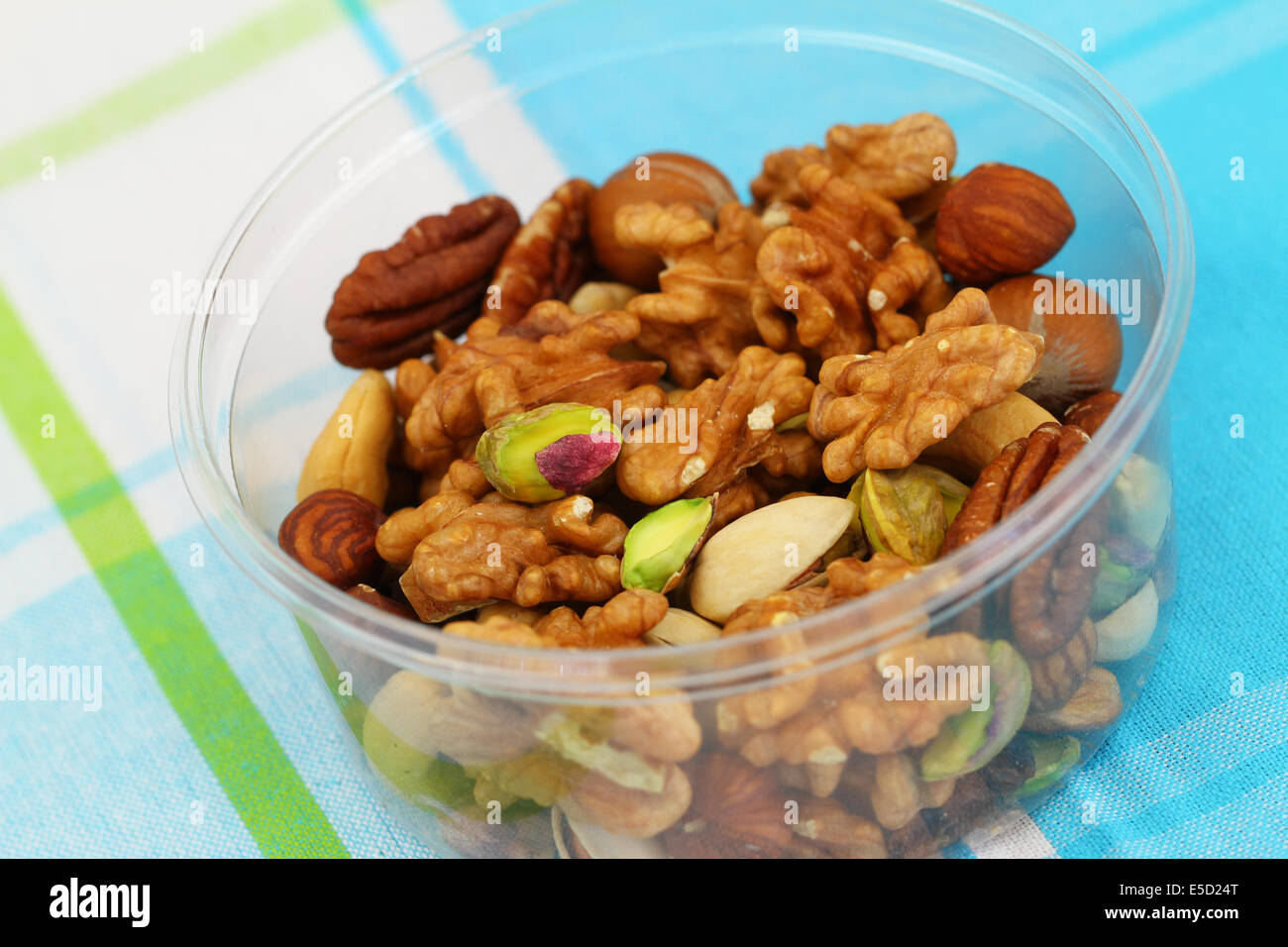 Mixed nuts in plastic box, close up Stock Photo - Alamy