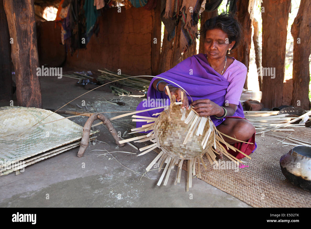 Tribal woman making baskets with dry bamboo strips. Pahadi Korba tribe ...