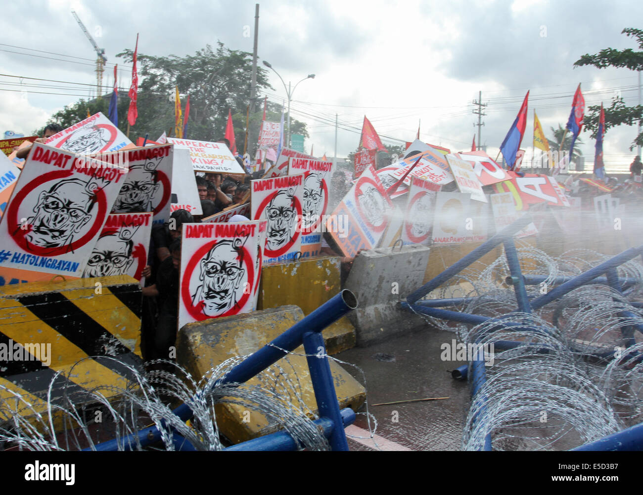 Manila, Philippines. 28th July, 2014. Protester bombarded with water ...