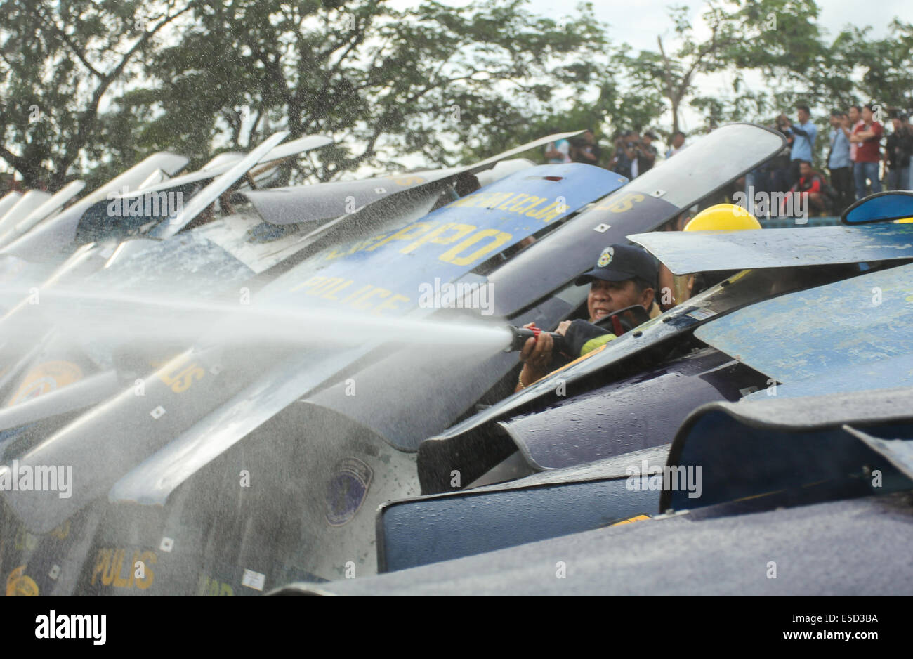 Manila, Philippines. 28th July, 2014. Protester bombarded with water ...