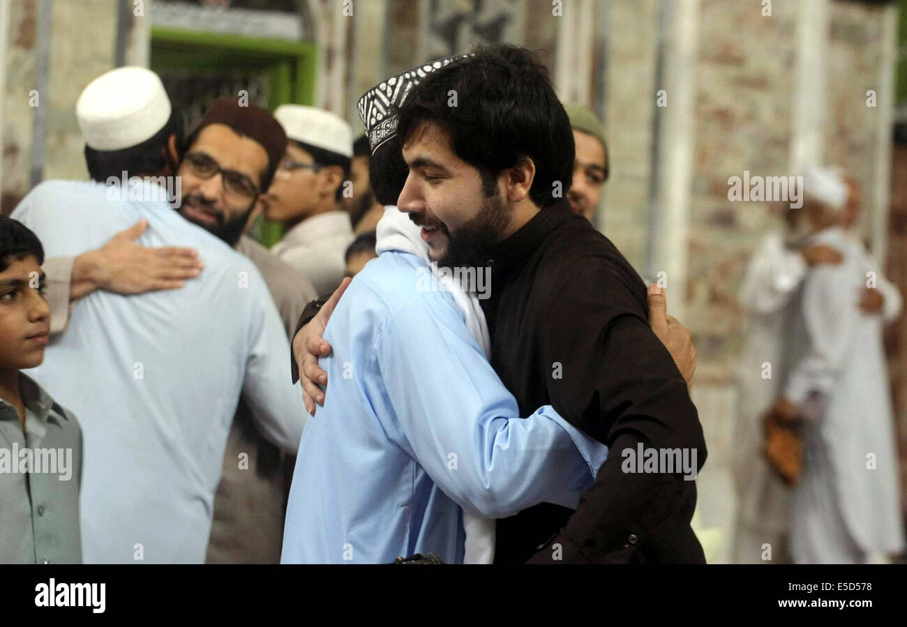 Faithful Muslims hug with each other after Eid-ul-Fitar prayer at ...