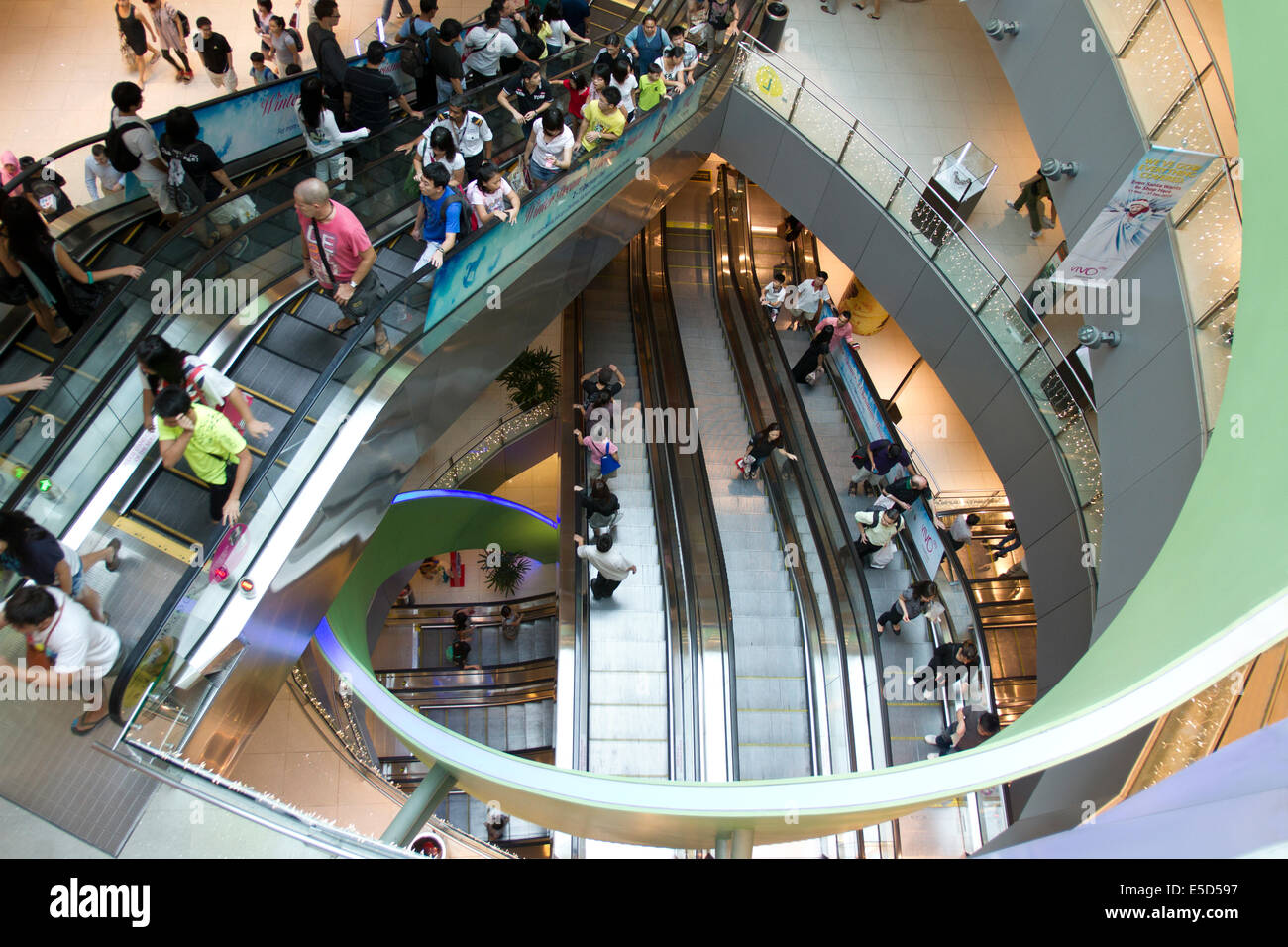 Shoppers on escalators in department store in Singapore Stock Photo - Alamy