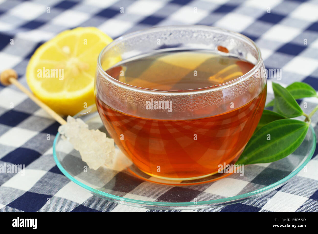 Cup of tea, sugar stick and lemon Stock Photo - Alamy