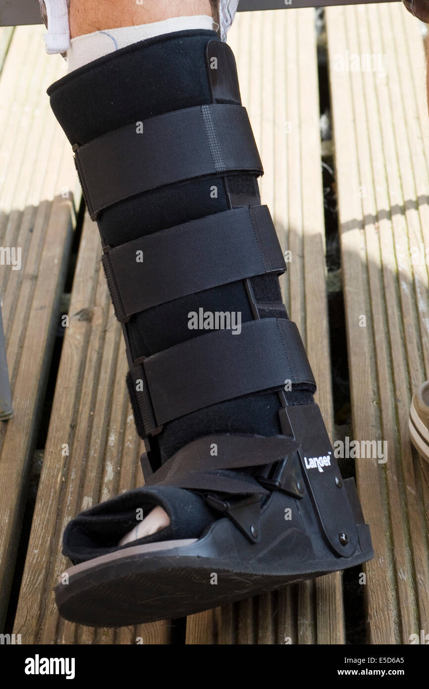 Mans leg encased in a medical walking boot after an Achilles heel ...