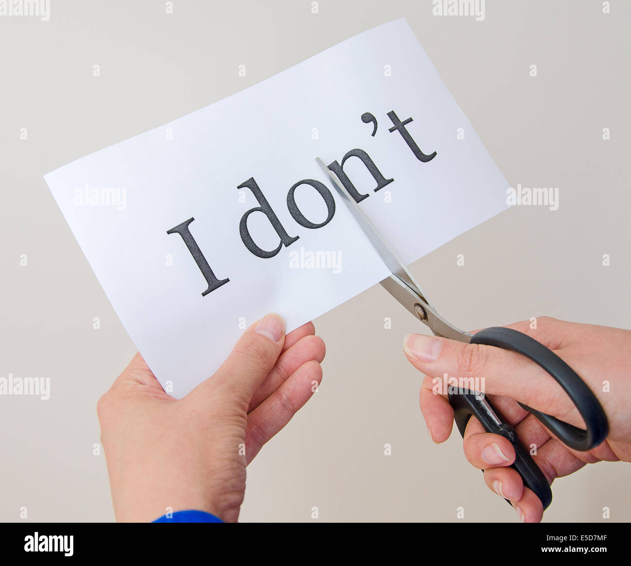 Female hand cutting paper with words. Concept Stock Photo - Alamy