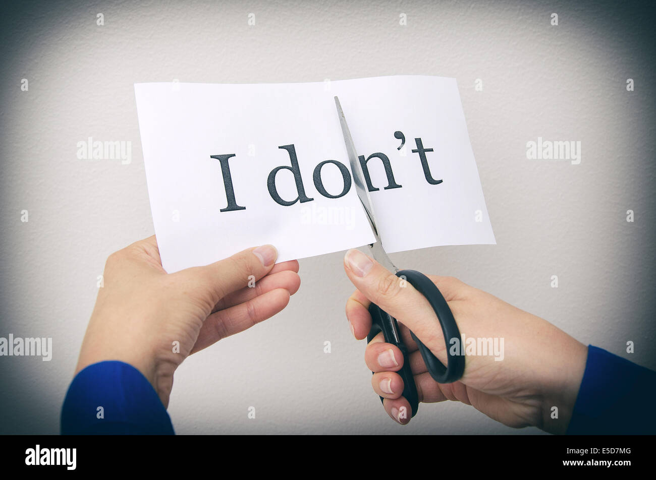 Female hand cutting paper with words. Concept Stock Photo - Alamy
