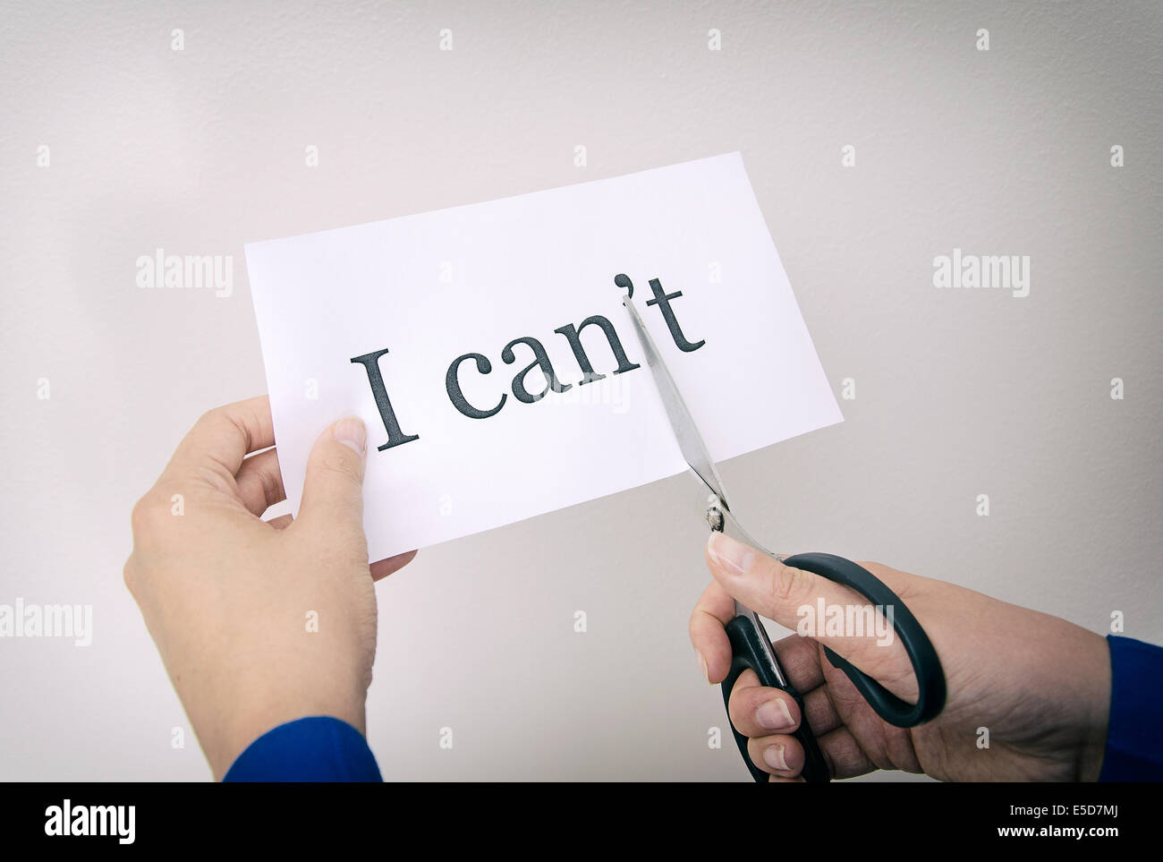 Female hand cutting paper with words. Concept Stock Photo - Alamy
