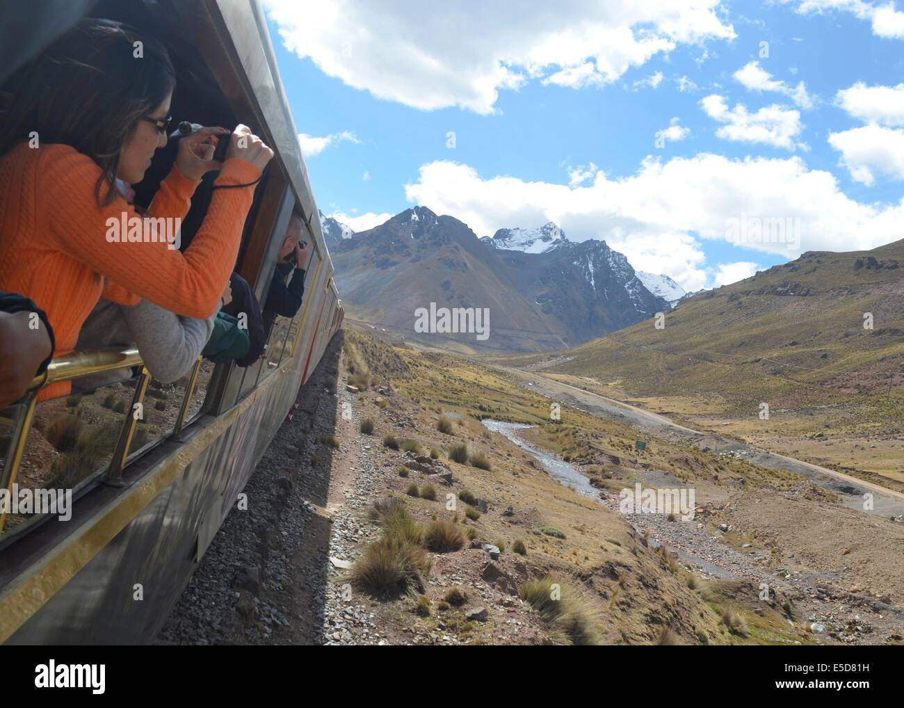 Tourists taking photos from the observation carriage on board the ...