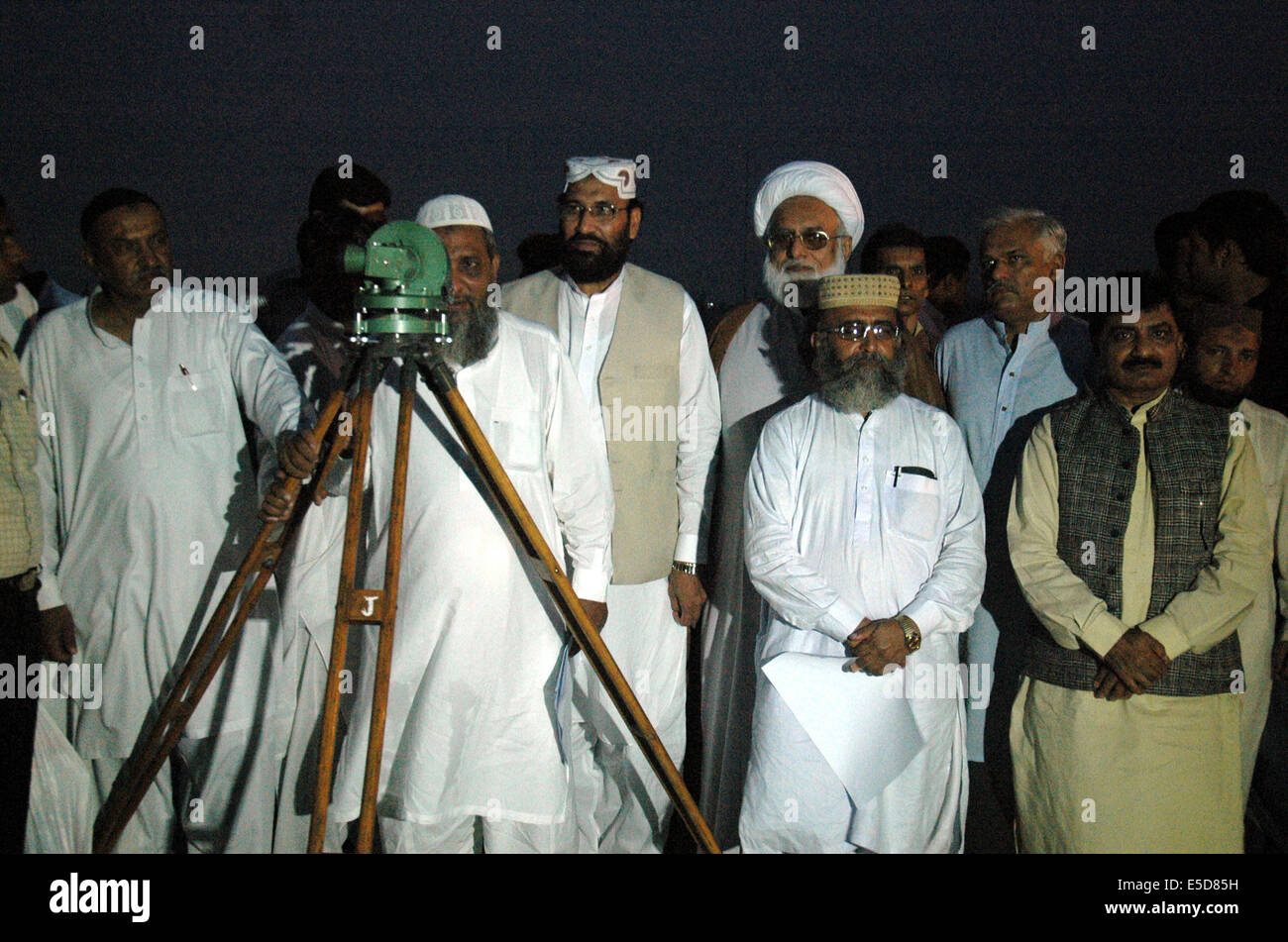 Lahore, Pakistan. 28th July, 2014. Pakistani Muslims look for the first ...