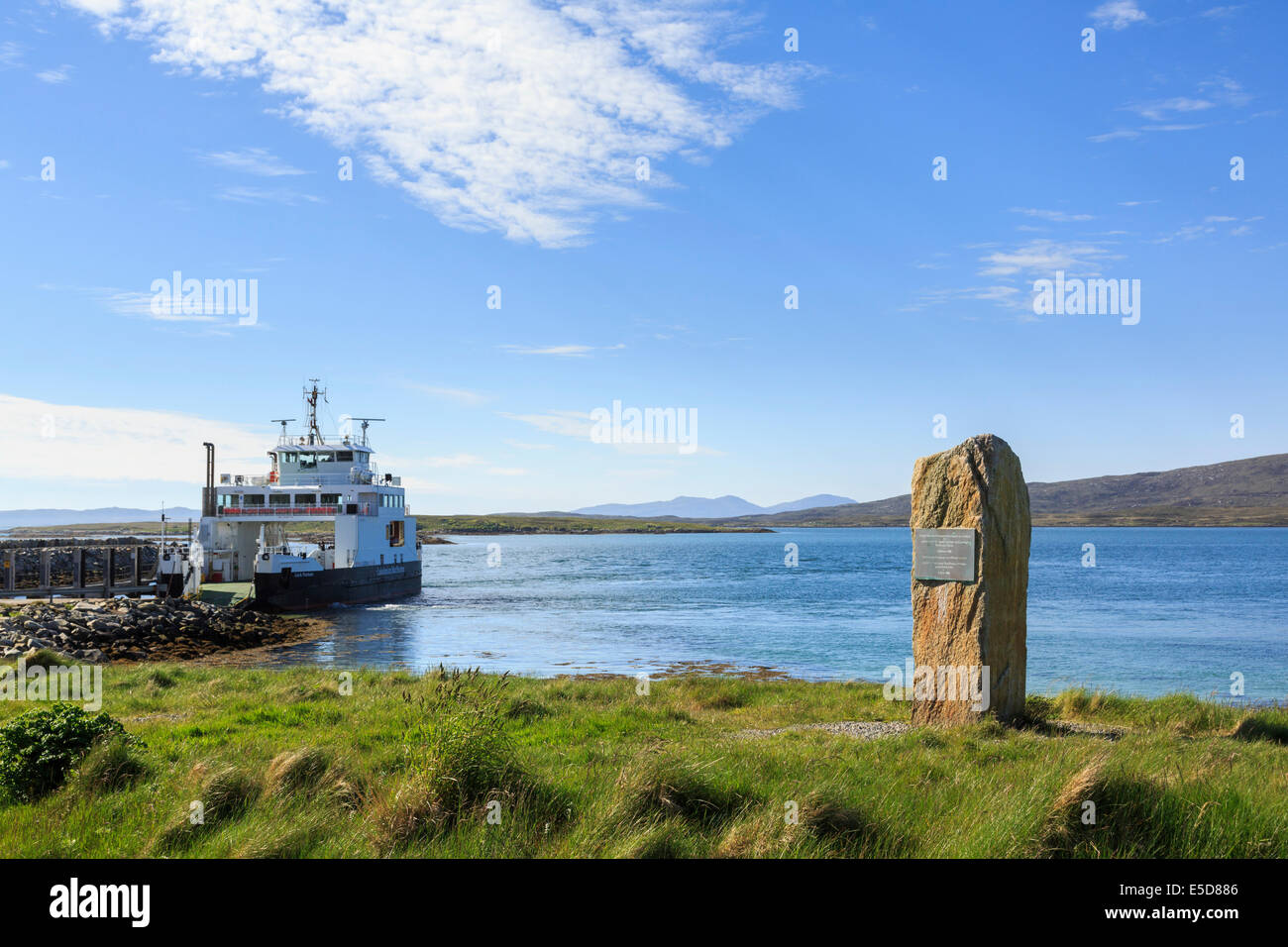 Causeway memorial stone and CalMac ferry by pier on Berneray Island ...