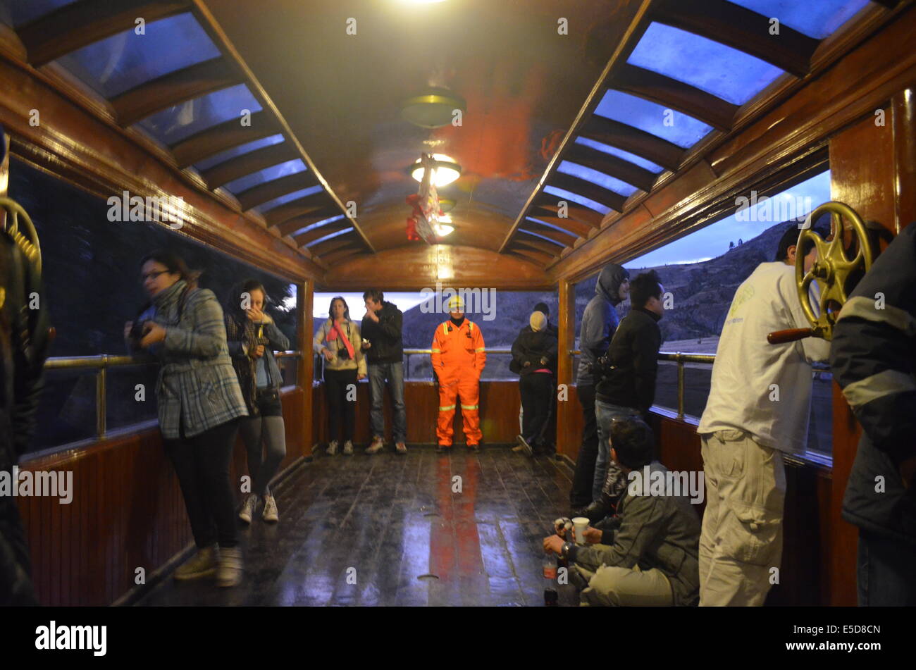 Tourists taking photos from the observation carriage on board the ...
