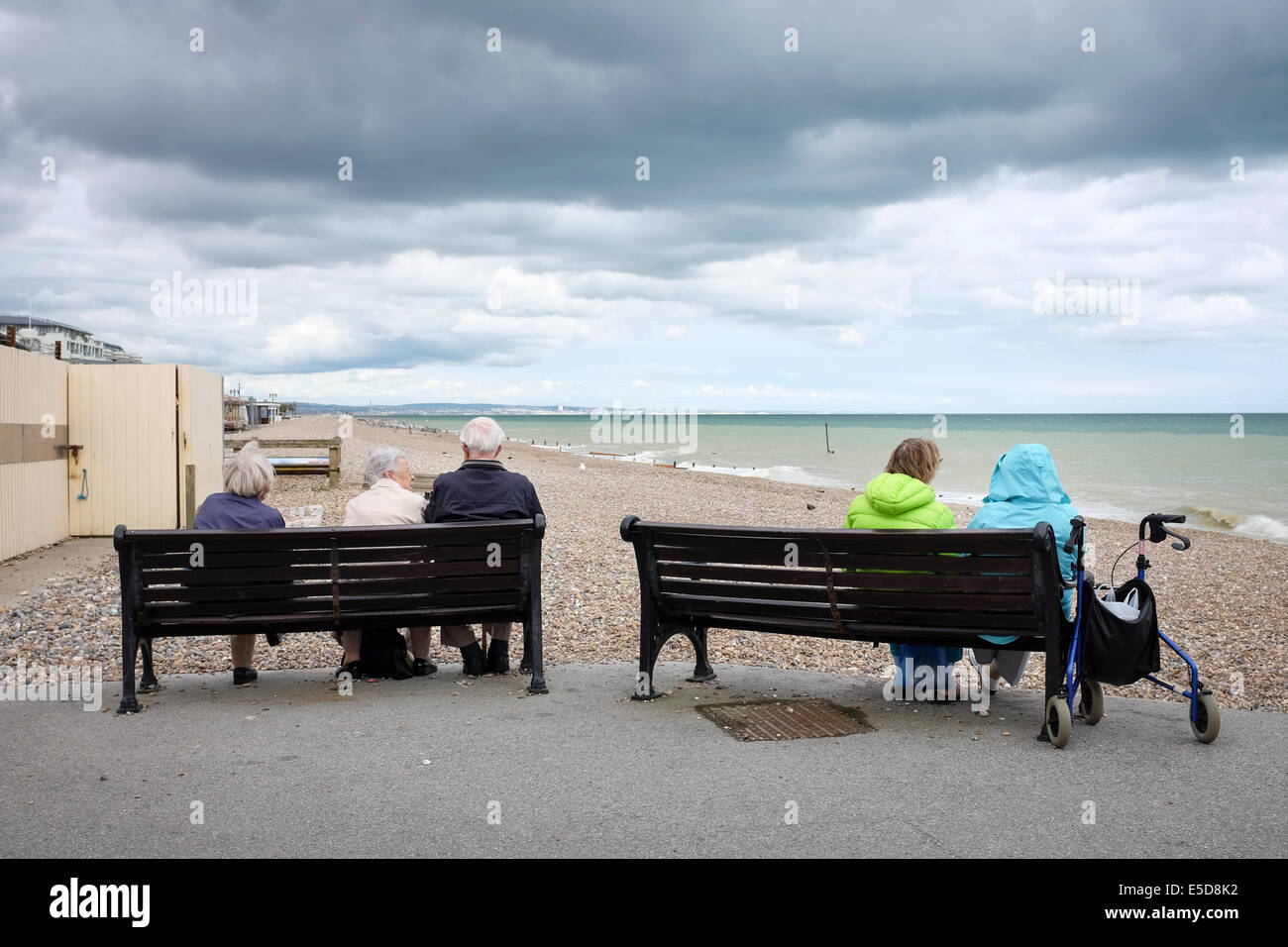 Old people on benches looking over the Worthing beach, England, UK ...