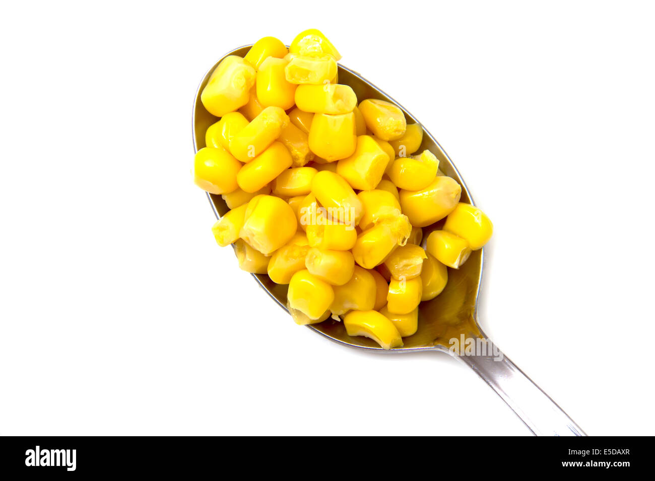 Corn on spoon on white background seen from near Stock Photo - Alamy
