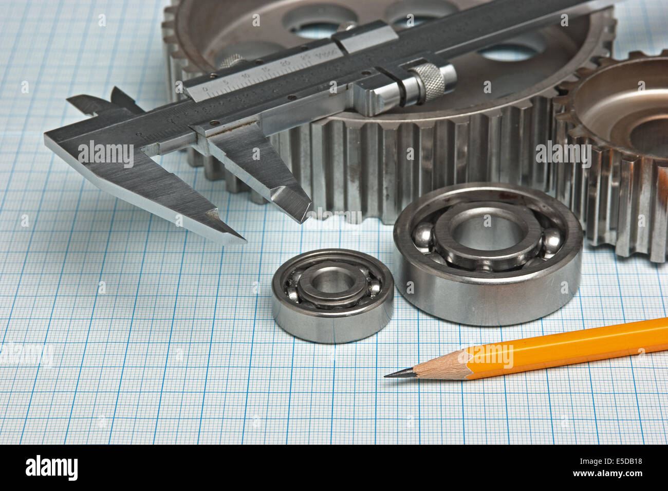 caliper with gears and bearings on graph paper Stock Photo - Alamy