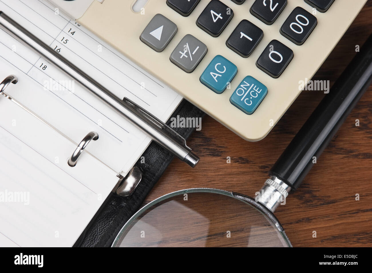 Book magnifying glass calculator hi-res stock photography and images ...