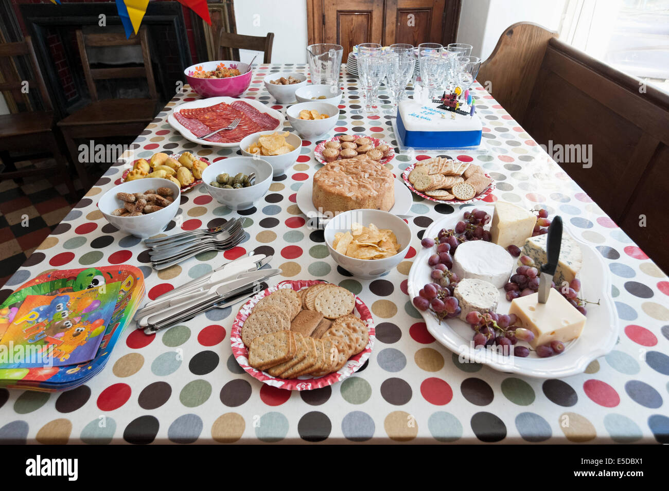 Colorful party table laid out with finger food nibbles and cakes Stock ...