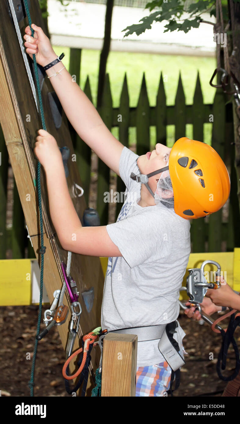 Teen boy climbing tree hi-res stock photography and images - Alamy
