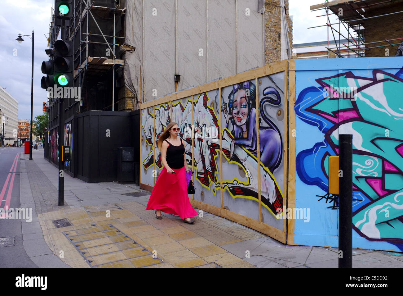 woman walking past Graffiti in East London Stock Photo - Alamy