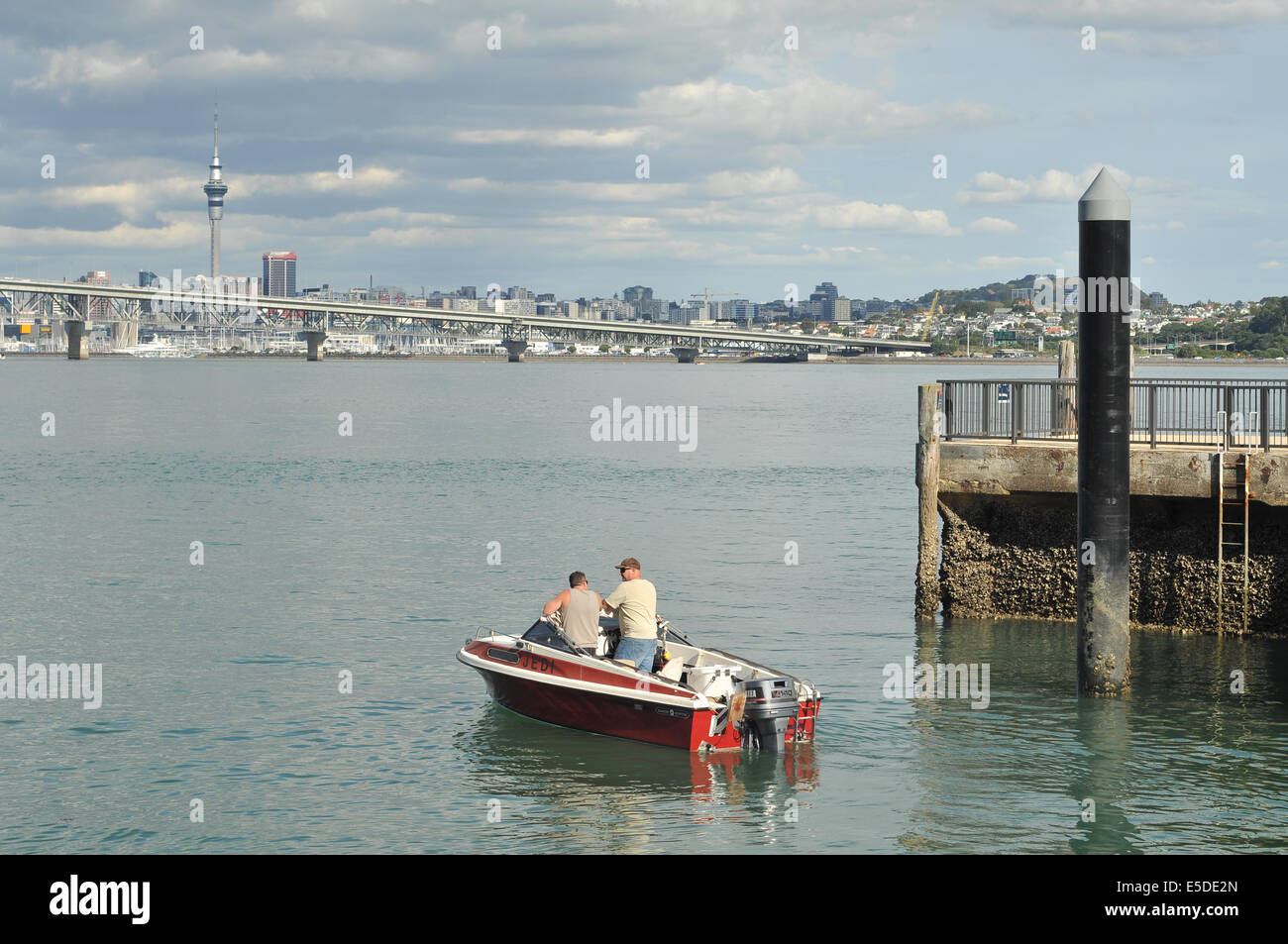 Two men going to sea on outboard engine powered boat in Auckland, New ...