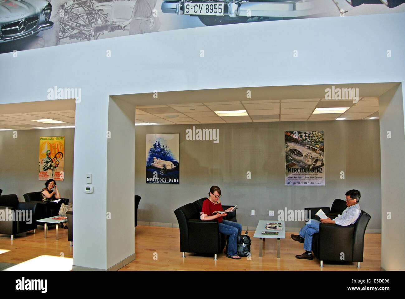 Mercedes Benz customers read while waiting to pick up cars Stock Photo ...