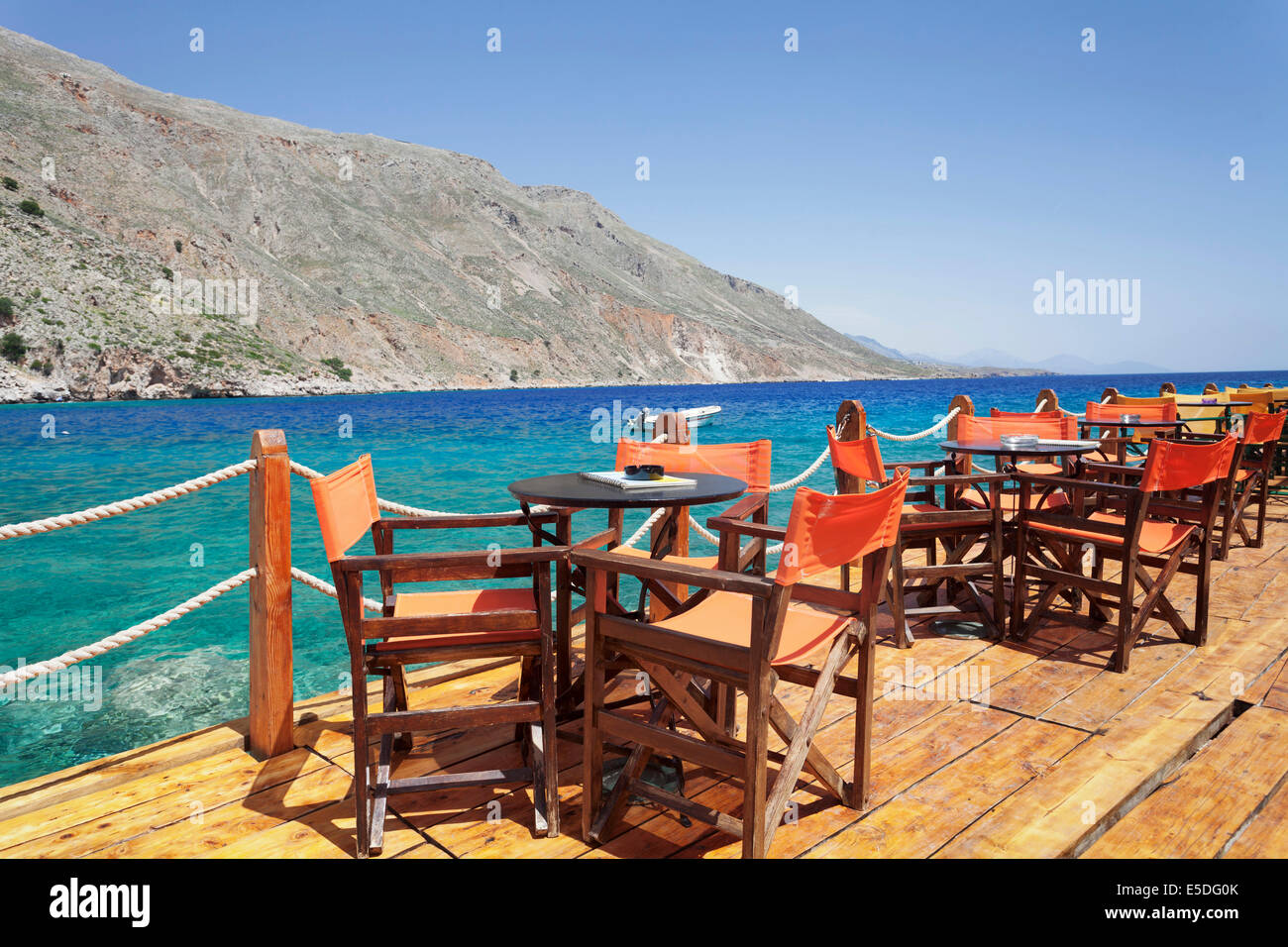 Cafe terrace on the harbour promenade, Loutro, South Crete, Crete ...
