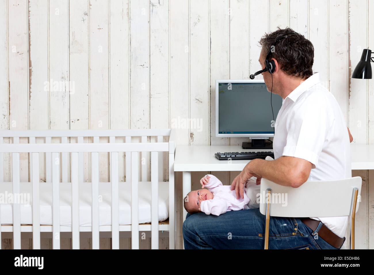 Man on cot baby hi-res stock photography and images - Alamy