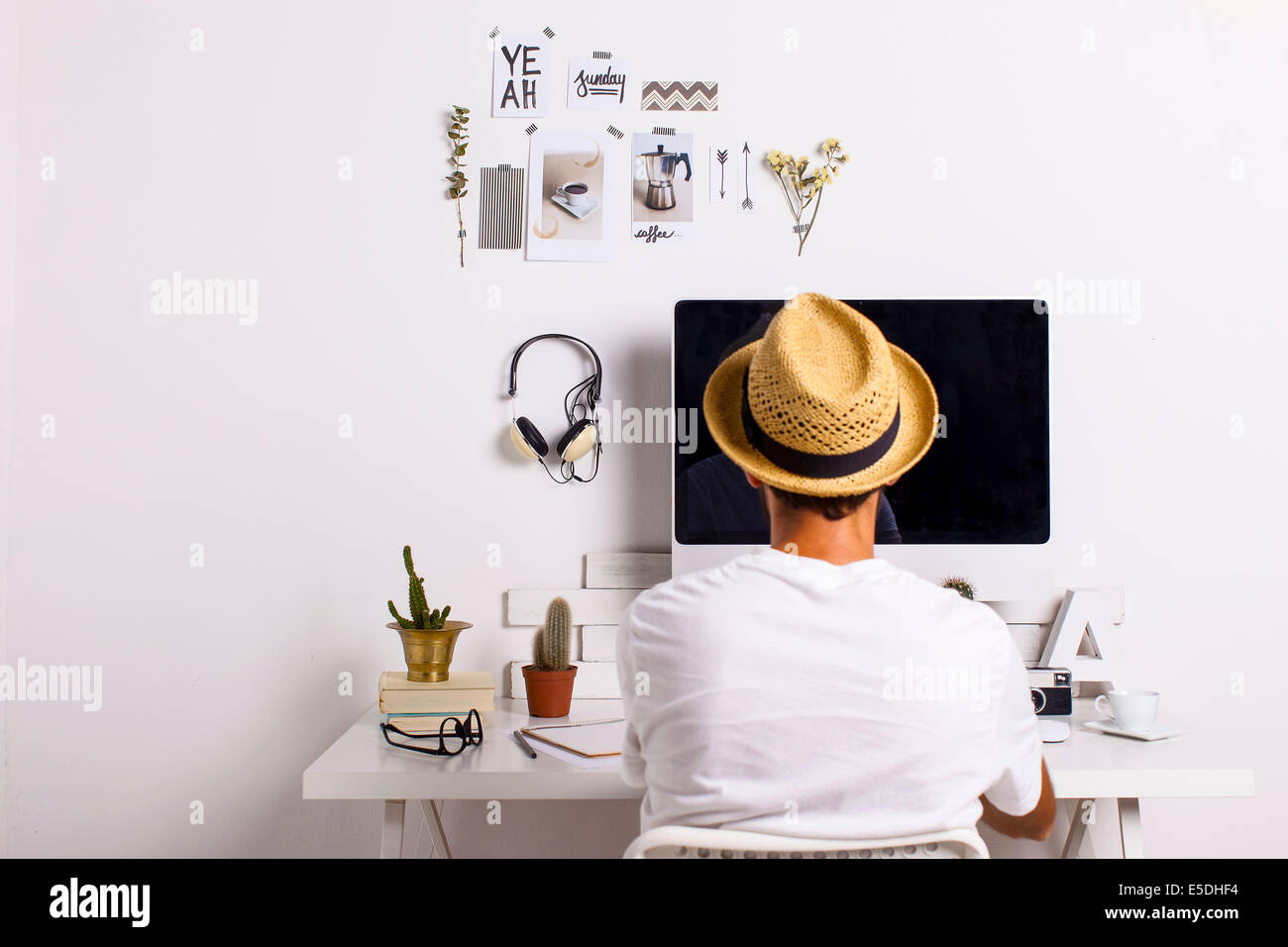 Man at desk in white workroom Stock Photo - Alamy