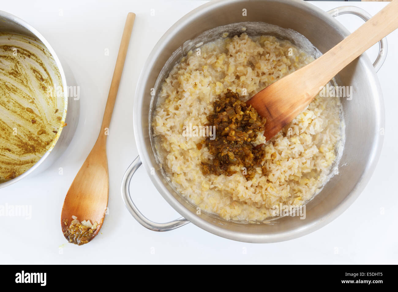 Pot of cooked rice and mungo beans with mixed herbs and steamed onions ...