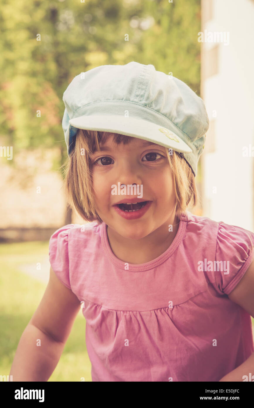 Portrait of smiling little girl wearing cap Stock Photo - Alamy