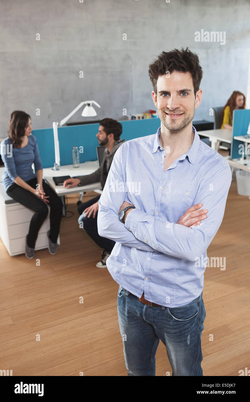 Portrait of man standing in the open space office Stock Photo - Alamy