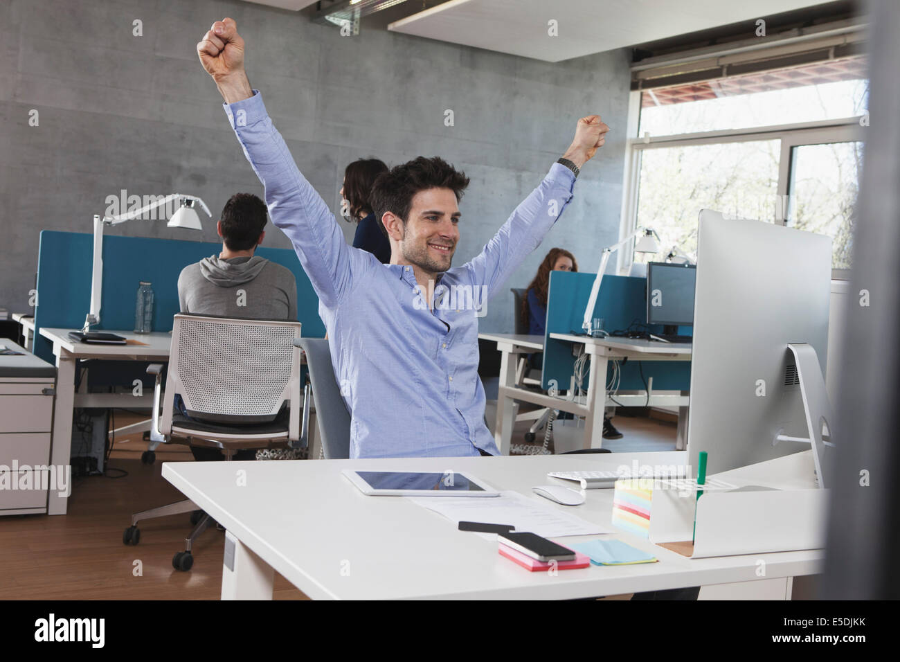 Portrait of successful man at his workplace in the office Stock Photo ...