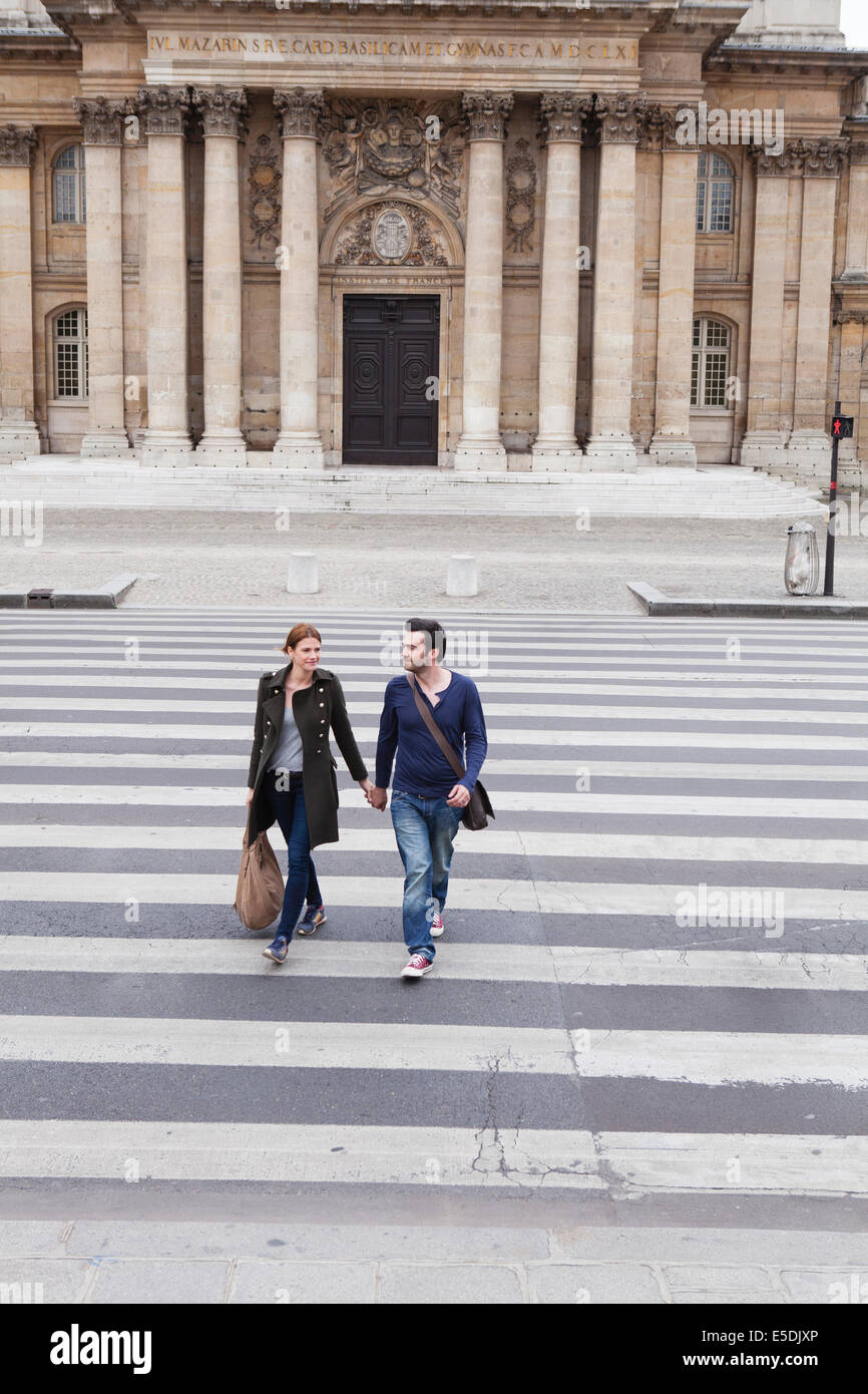 France, Paris, couple walking hand in hand on crosswalk Stock Photo - Alamy