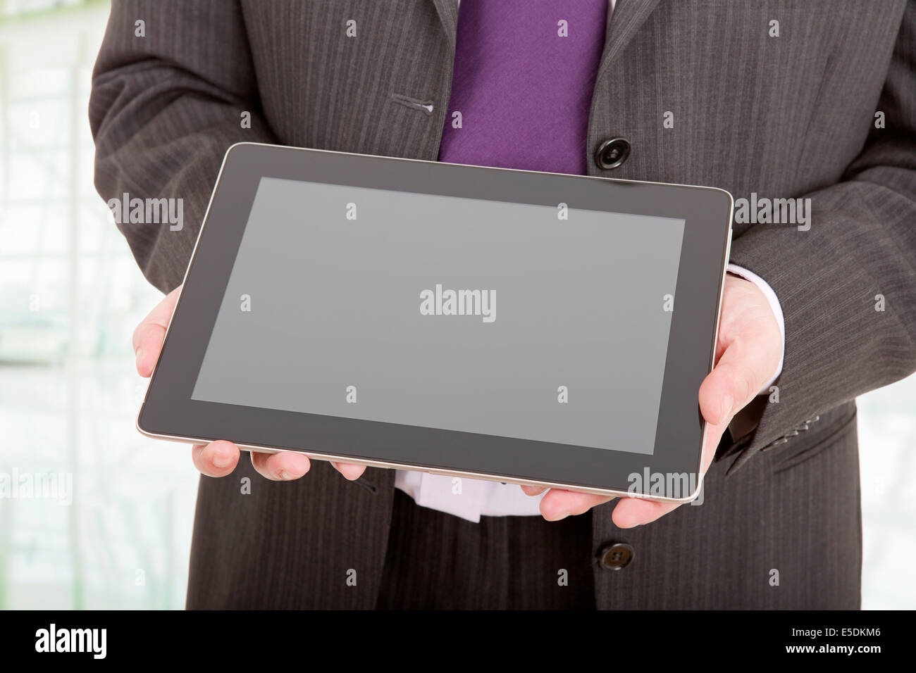 businessman showing a tablet pc at the office Stock Photo - Alamy