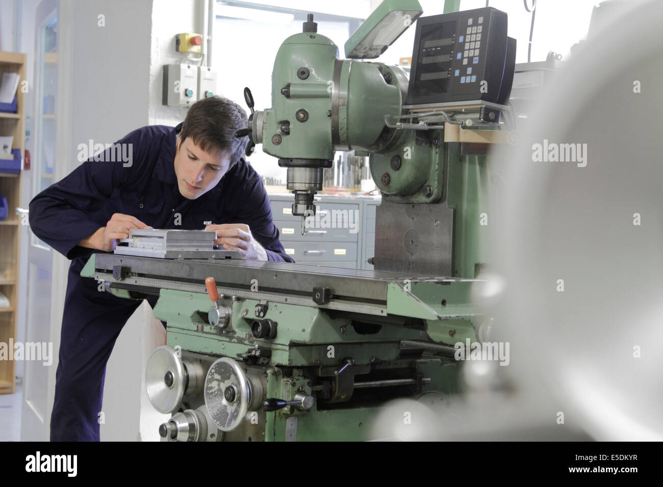 Germany, Young mechanic working in crafts workshop Stock Photo - Alamy