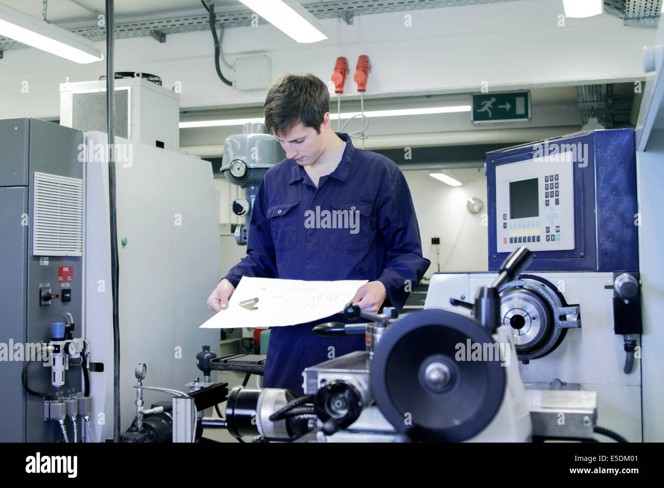 Germany, Young mechanic working in crafts workshop Stock Photo - Alamy